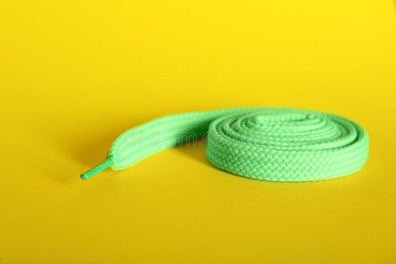 Rolled Mint Shoe Lace on Yellow Background Stock Photo - Image of cloth ...