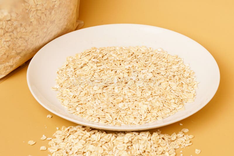 Rolled Oats on White Plate Isolated on White Background Stock Photo ...