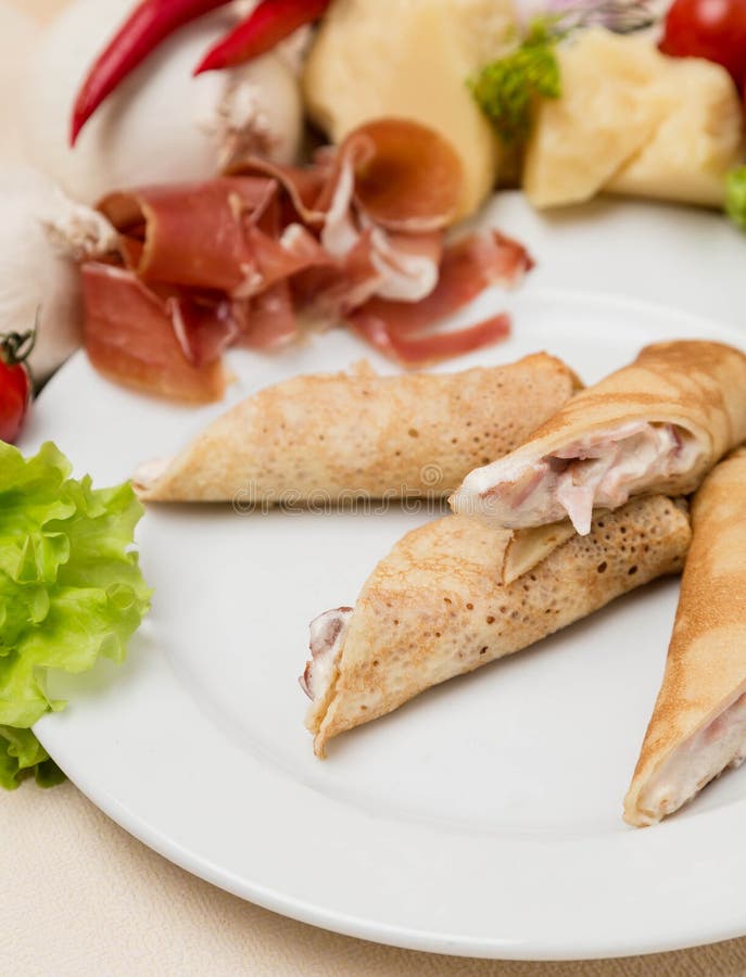 Rolled Pancake with Bacon, Cheese and Garnish on White Plate Stock ...