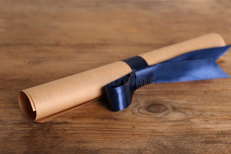 Rolled Student`s Diploma with Blue Ribbon on Wooden Table Stock Photo ...