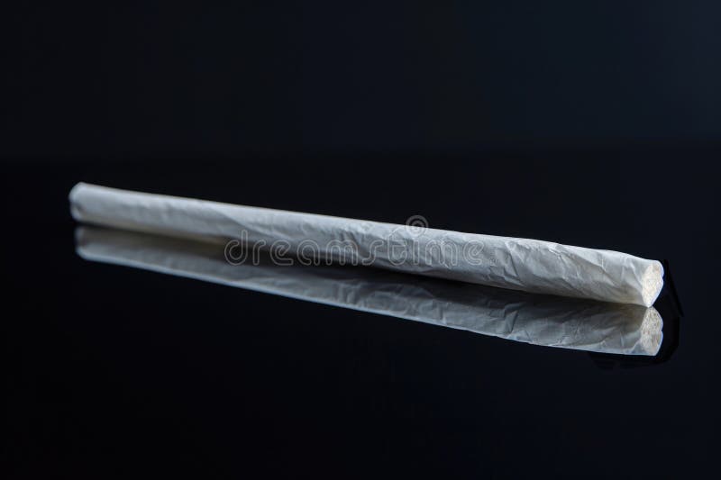 A Rolled Up Cigarette Sits on a Table, Ready To Be Lit Stock Image ...