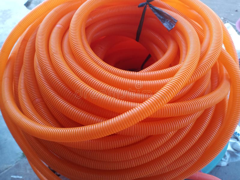 Rolled-Up Coil of Orange Plastic Piping Stock Photo - Image of outdoor ...