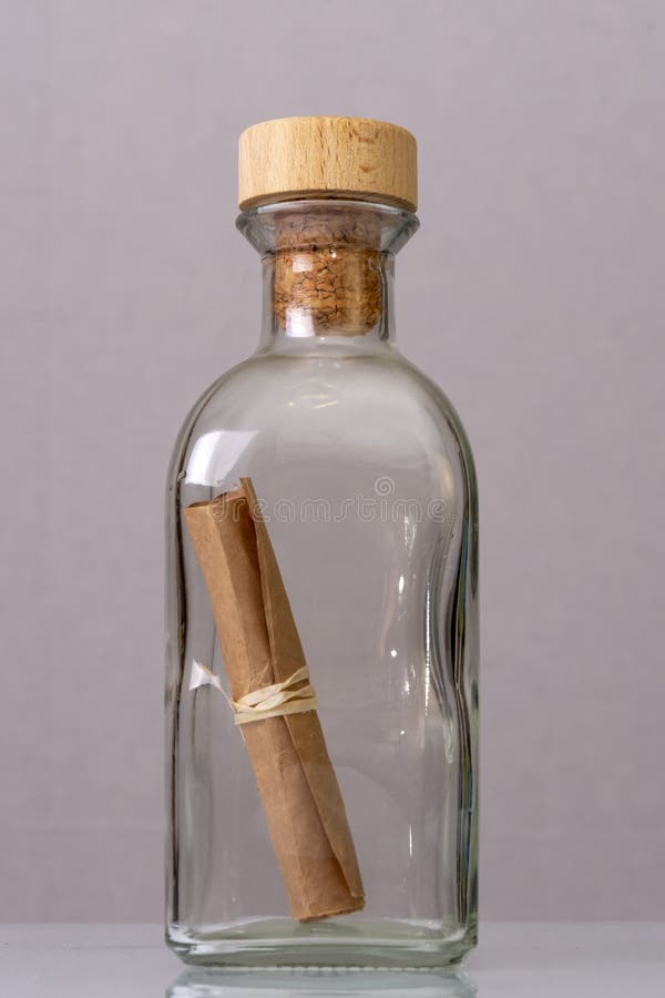 A Rolled-up Old Paper Note in a Glass Bottle with a Cork on a Light ...