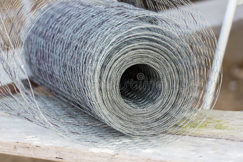 Rolled Up Silver Construction Mesh Sitting on a Wood Surface Stock ...