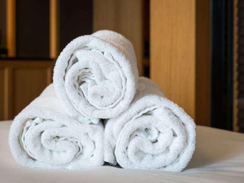 Rolled White Bath Towels on Top of Bed Stock Photo - Image of ...