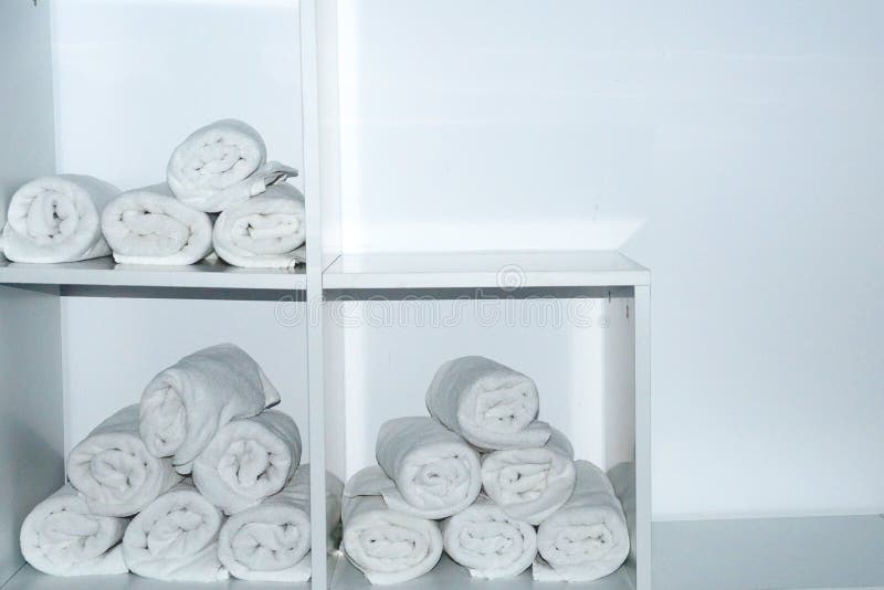 Rolled White Towels on White Shelves Close-up Stock Photo - Image of ...