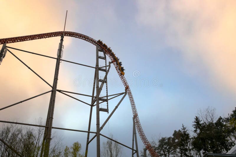 Roller Coaster in the Amusement Park with Sun Stock Photo - Image of ...