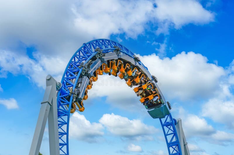 Roller Coaster Cart with People Riding it Goes through a Loop Upside ...