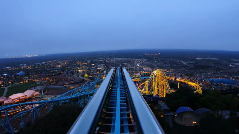 Roller Coaster Track View from Inside the Car at Dusk, Overlooking City ...