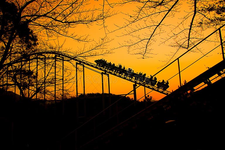 Roller Coaster Train is Going Up at Autumn Sunset Stock Photo - Image ...
