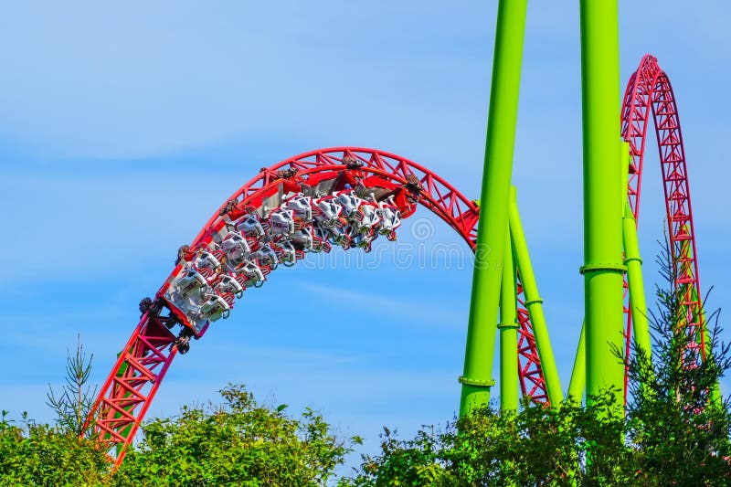 Roller Coaster Cart with People Riding it Goes through a Loop Upside ...