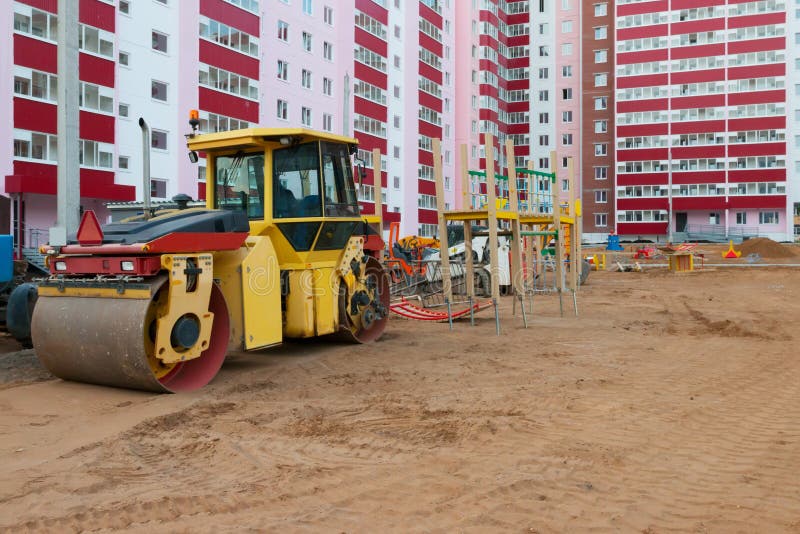 Roller at Construction Site Next To New Building and Playgro Stock ...