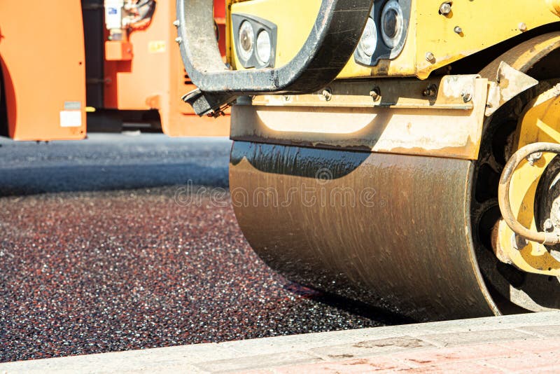 The Roller Flattens the Asphalt Tar, Paving the New Asphalt Stock Photo ...