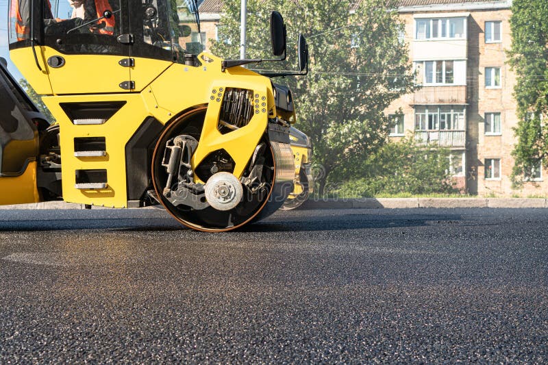 The Roller Flattens the Asphalt Tar, Paving the New Asphalt Stock Photo ...