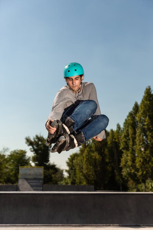 Boy with Inline Skates, Rollerblade, Doing a Jump in a Skate Park Stock ...