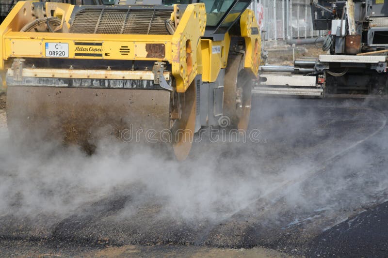 Roller Machine Compressing the Asphalt Behind the Paver Editorial Image ...