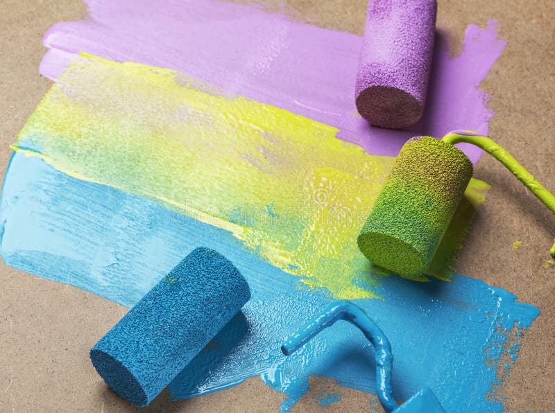 Roller Paint Roller with Blue, Pink and Green Paint. Repair Concept ...