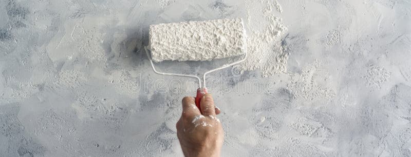 A Roller Painting a White Wall with Gray Color, Offering Ample Copy ...