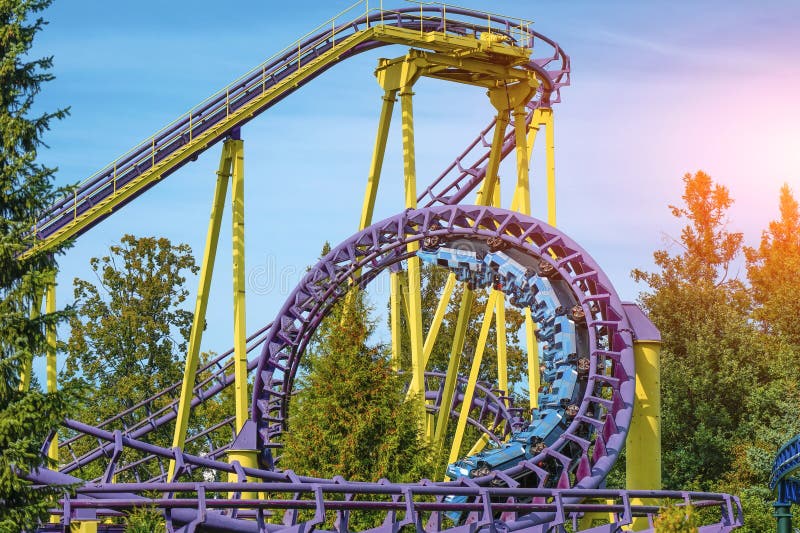 Rollercoaster Cart with People Riding it Goes High Speed through Loop ...