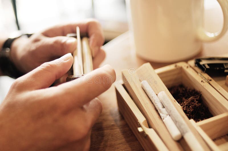 Rolling a cigarette stock image. Image of machine, health - 85527139