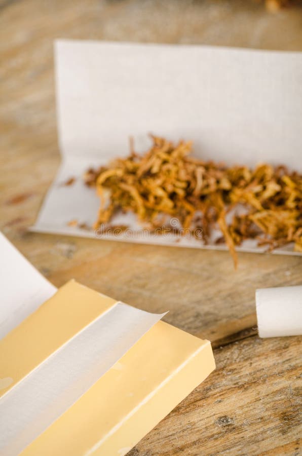 Rolling cigarettes stock image. Image of studio, life - 63528009