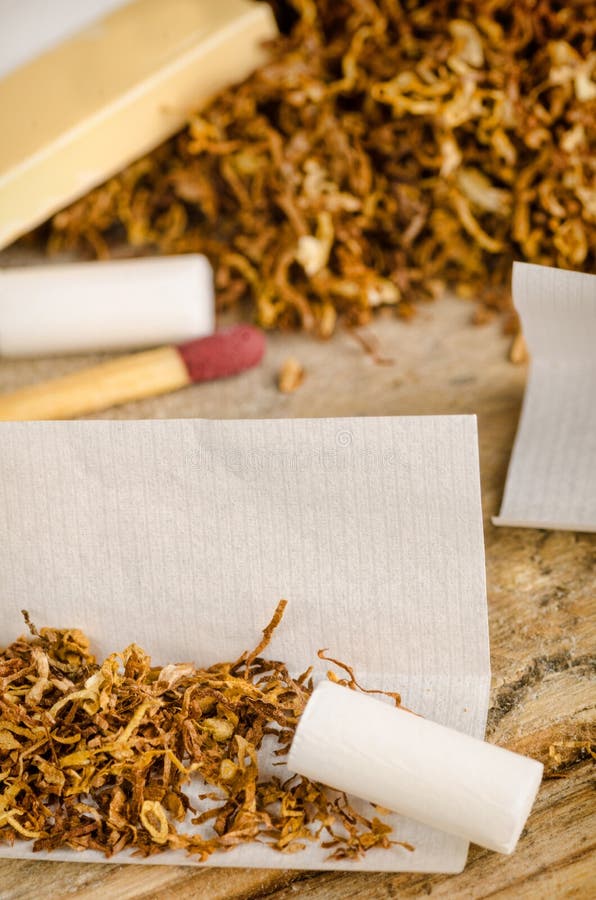 Rolling cigarettes stock image. Image of shot, cigarette - 63677565
