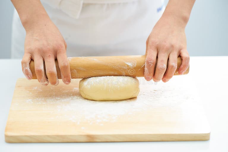 Rolling the Dough with a Rolling Pin, Bread Making Process Stock Photo ...