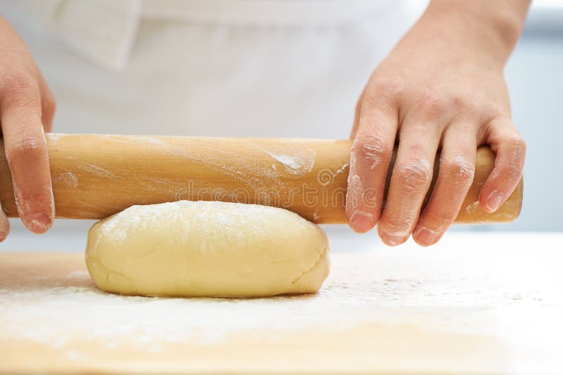 Rolling the Dough with a Rolling Pin, Bread Making Process Stock Photo ... Rolling the Dough with a Rolling Pin, Bread Making Process Stock Photo ...