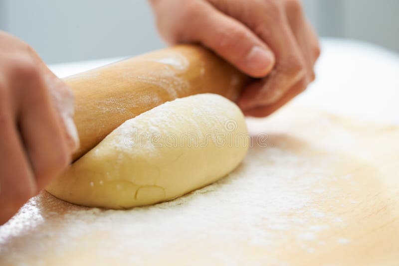 Rolling the Dough with a Rolling Pin, Bread Making Process Stock Photo ...