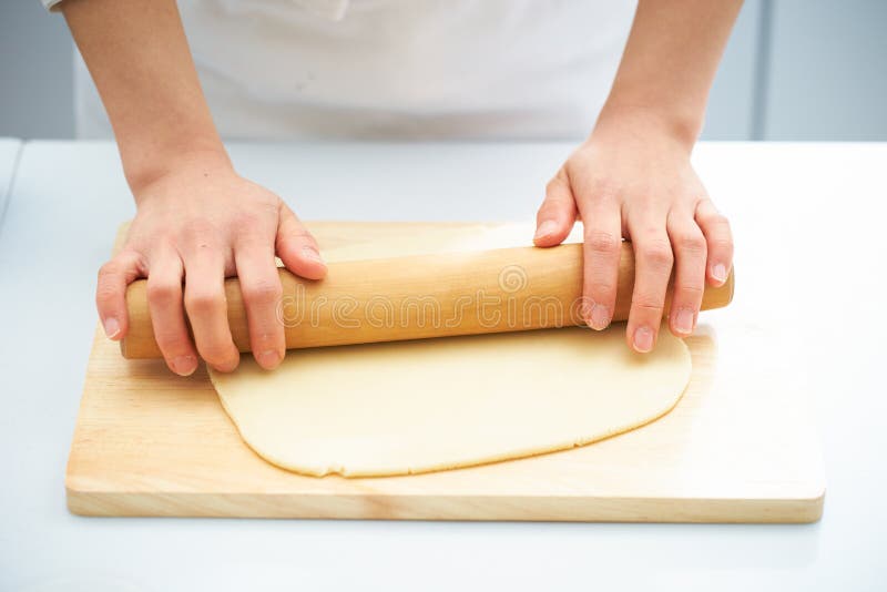 Rolling the Dough with a Rolling Pin, Bread Making Process Stock Image ... Rolling the Dough with a Rolling Pin, Bread Making Process Stock Image ...