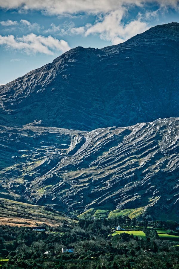 Rolling Hills and Sharp Mountain Peaks Create a Dramatic Contrast ...