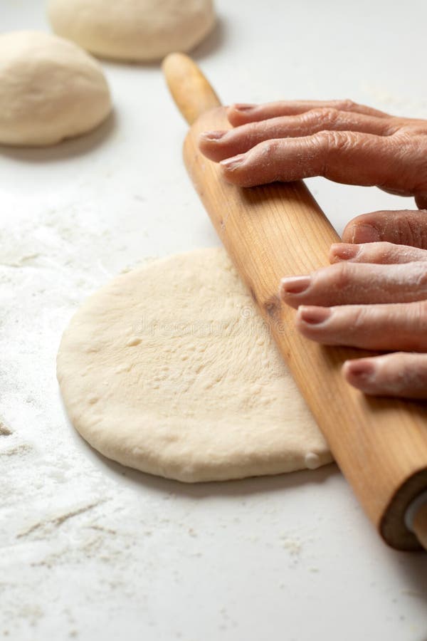 Rolling Pin on Dough on White Kitchen Table with Wheat Flour Stock ...