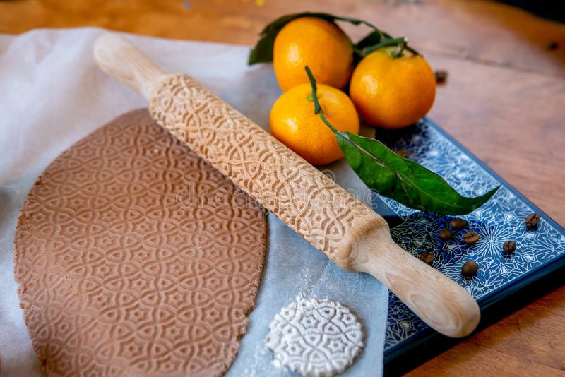 Rolling Pin with a Pattern on a Wooden Decorated Table Covered with ...