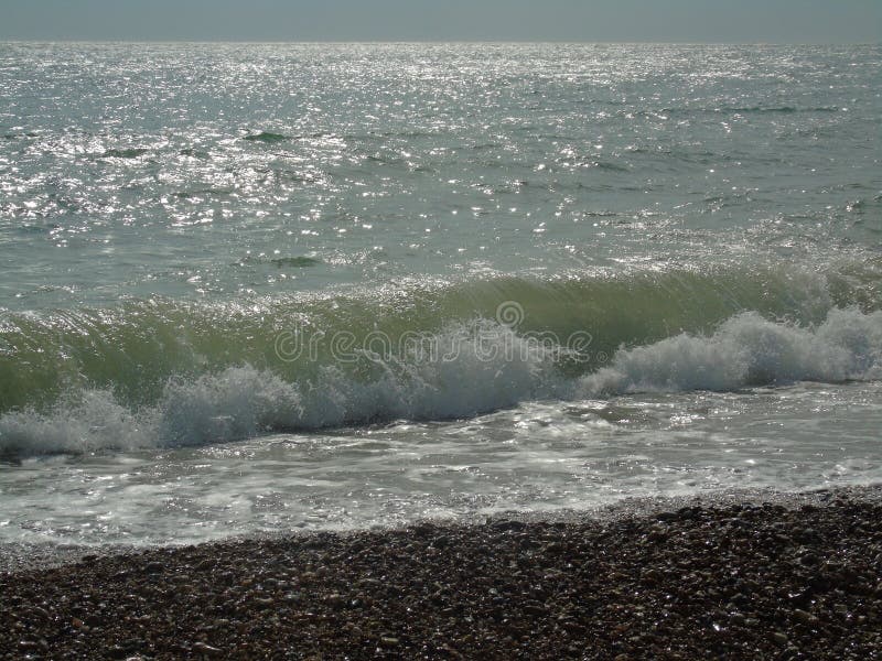 Rolling Wave on a Sunny Day Stock Photo - Image of wave, pebble: 247778294
