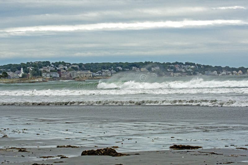 Rolling Waves with Spray Along the Muddy Sandy Beach Stock Photo ...