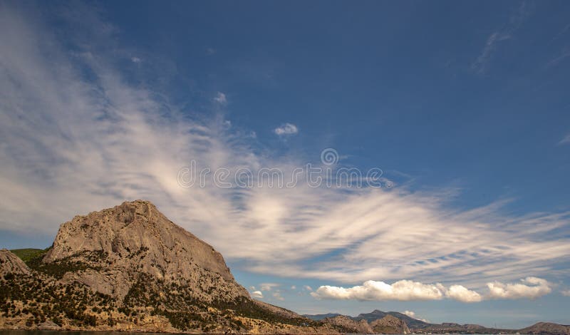 Rolling White Clouds Over the Big Rock Stock Image - Image of rock ...