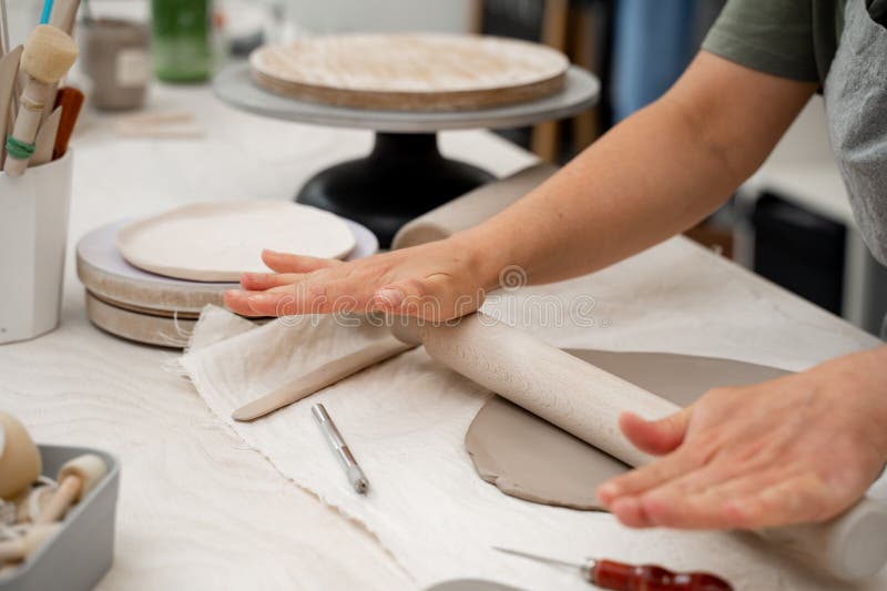 Rolling Wooden Stick To Make Flat Sheet of Clay. Preparing Clay for ...
