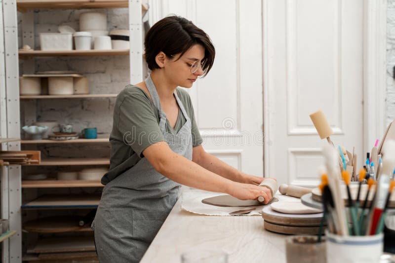 Rolling Wooden Stick To Make Flat Sheet of Clay. Preparing Clay for Cutting and Assembling it ...