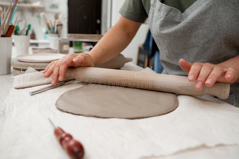 Rolling Wooden Stick To Make Flat Sheet of Clay. Preparing Clay for ...