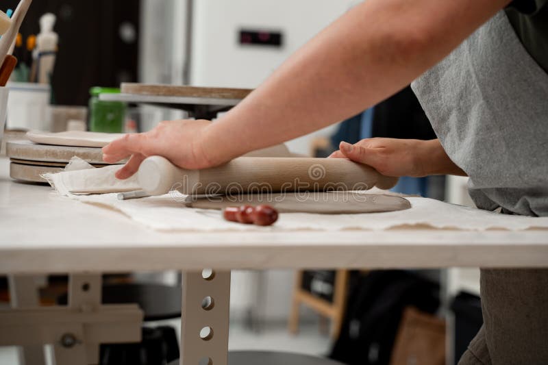 Rolling Wooden Stick To Make Flat Sheet of Clay. Preparing Clay for ...