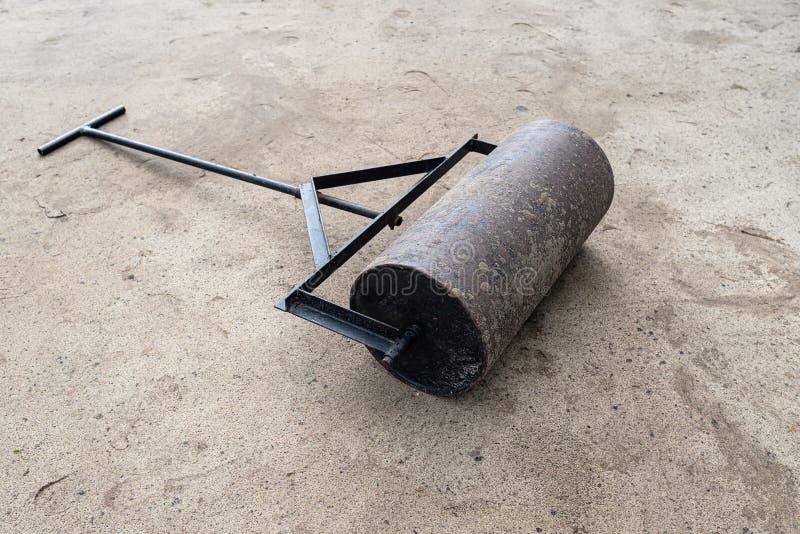 Rolling Yellow Sand with a Steel Roller for a Garden Pool. Stock Image ...