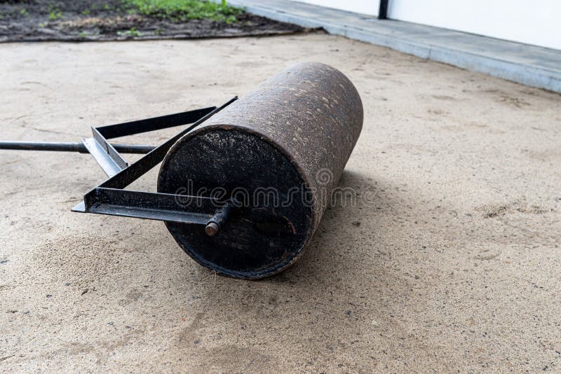 Rolling Yellow Sand with a Steel Roller for a Garden Pool. Stock Image ...