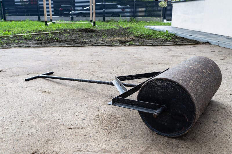 Rolling Yellow Sand with a Steel Roller for a Garden Pool. Stock Photo ...