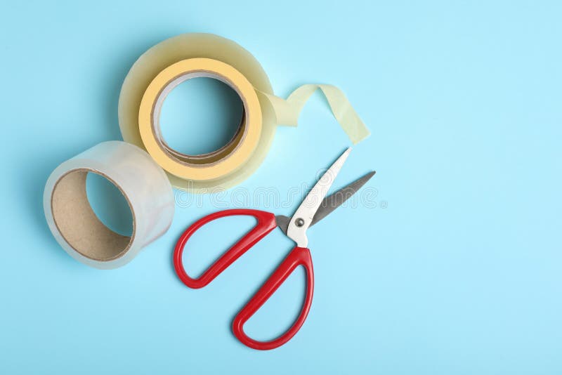 Rolls of Adhesive Tape and Scissors on Light Blue Background, Flat Lay ...