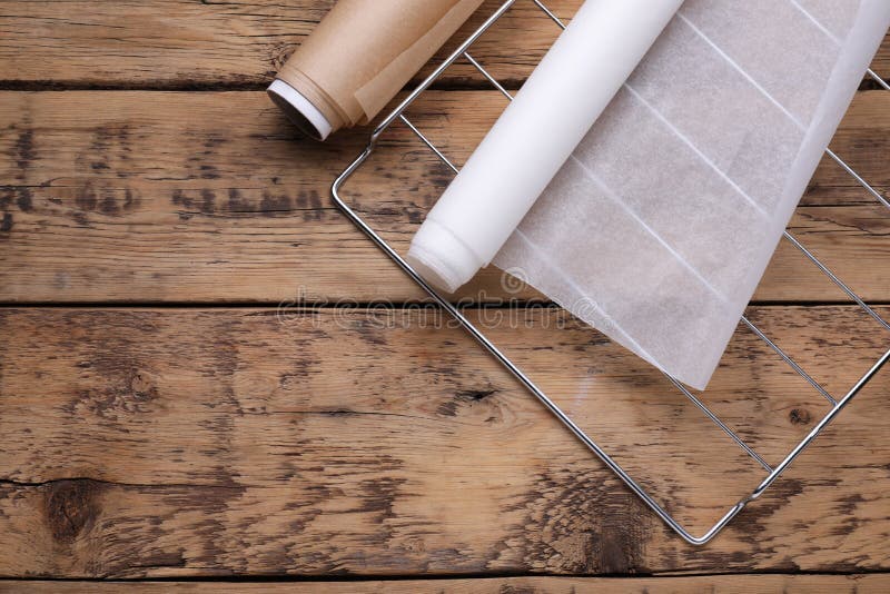 Rolls of Baking Parchment Paper and Cooling Rack on Wooden Table, Flat ...