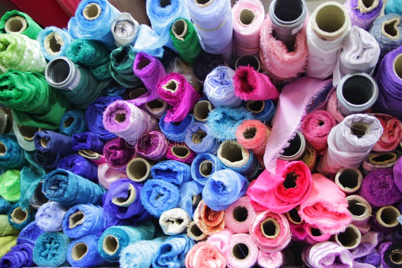 Rolls of colored fabrics stock photo. Image of industry - 141599708
