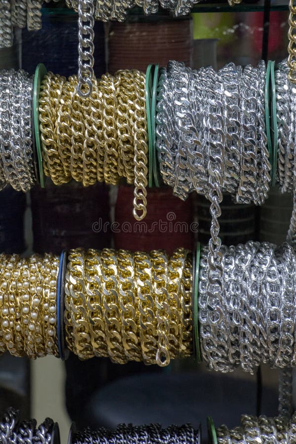 Rolls of decorative chains stock image. Image of holding - 94989449