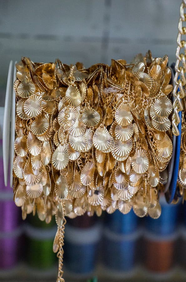 Rolls of decorative chains stock photo. Image of hand - 94989738