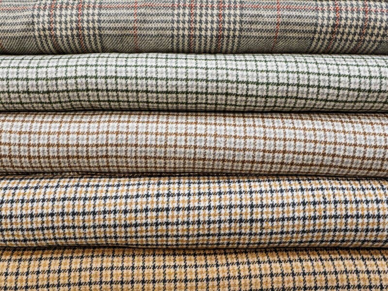 Rolls of Different Checkered Fabrics for Sewing Coats Close-up. Samples ...
