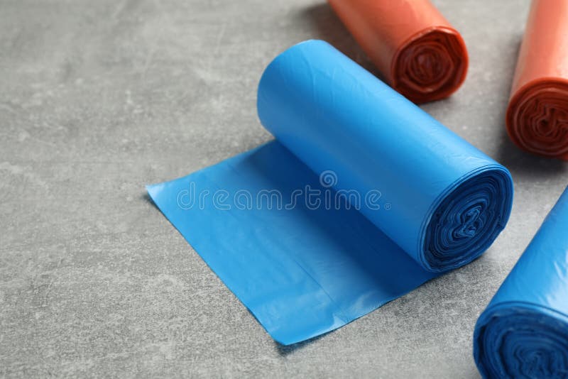 Rolls of Different Color Garbage Bags on Light Grey Stone Table Stock ...